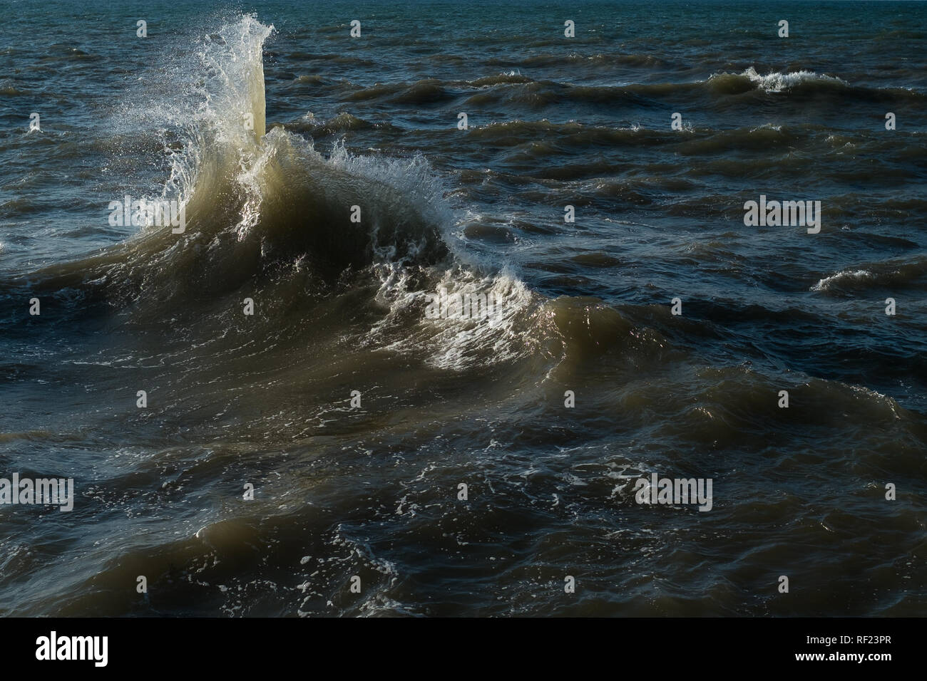 Splash of ocean waves against the backdrop of calm water Stock Photo ...