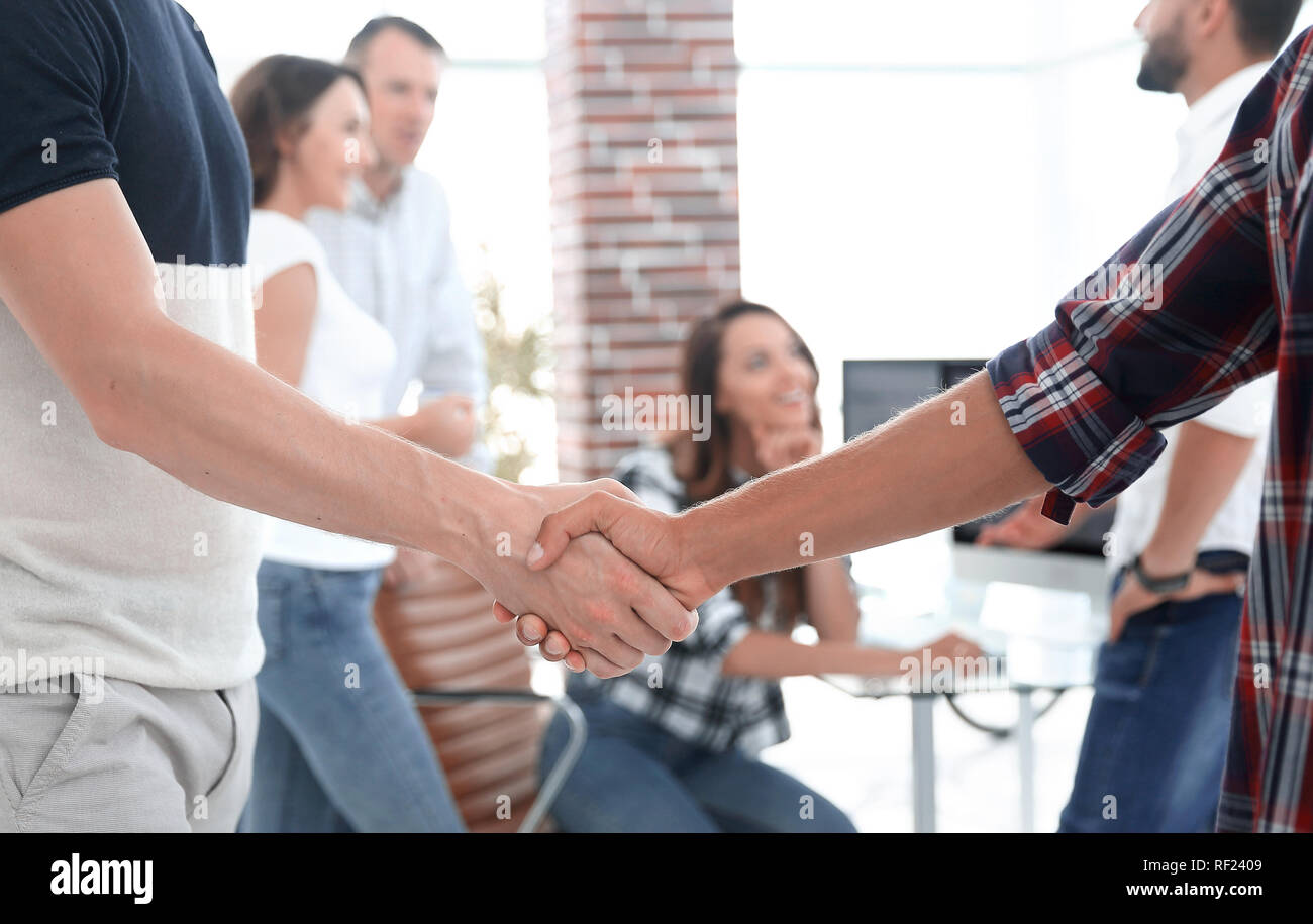 handshake colleagues in creative office Stock Photo - Alamy