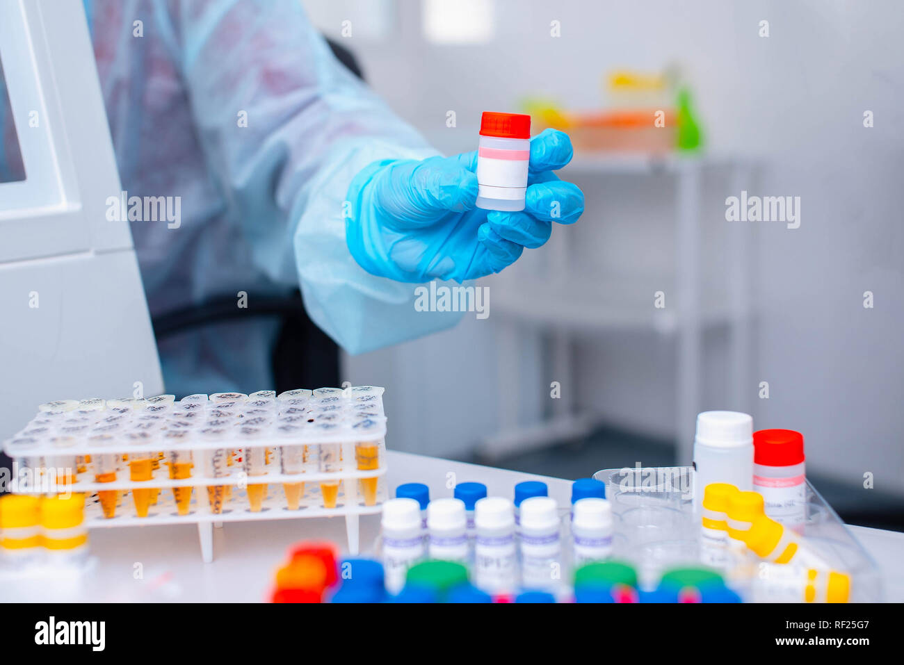 Dna test in the lab. Test tubes with biomaterials on the table in the ...