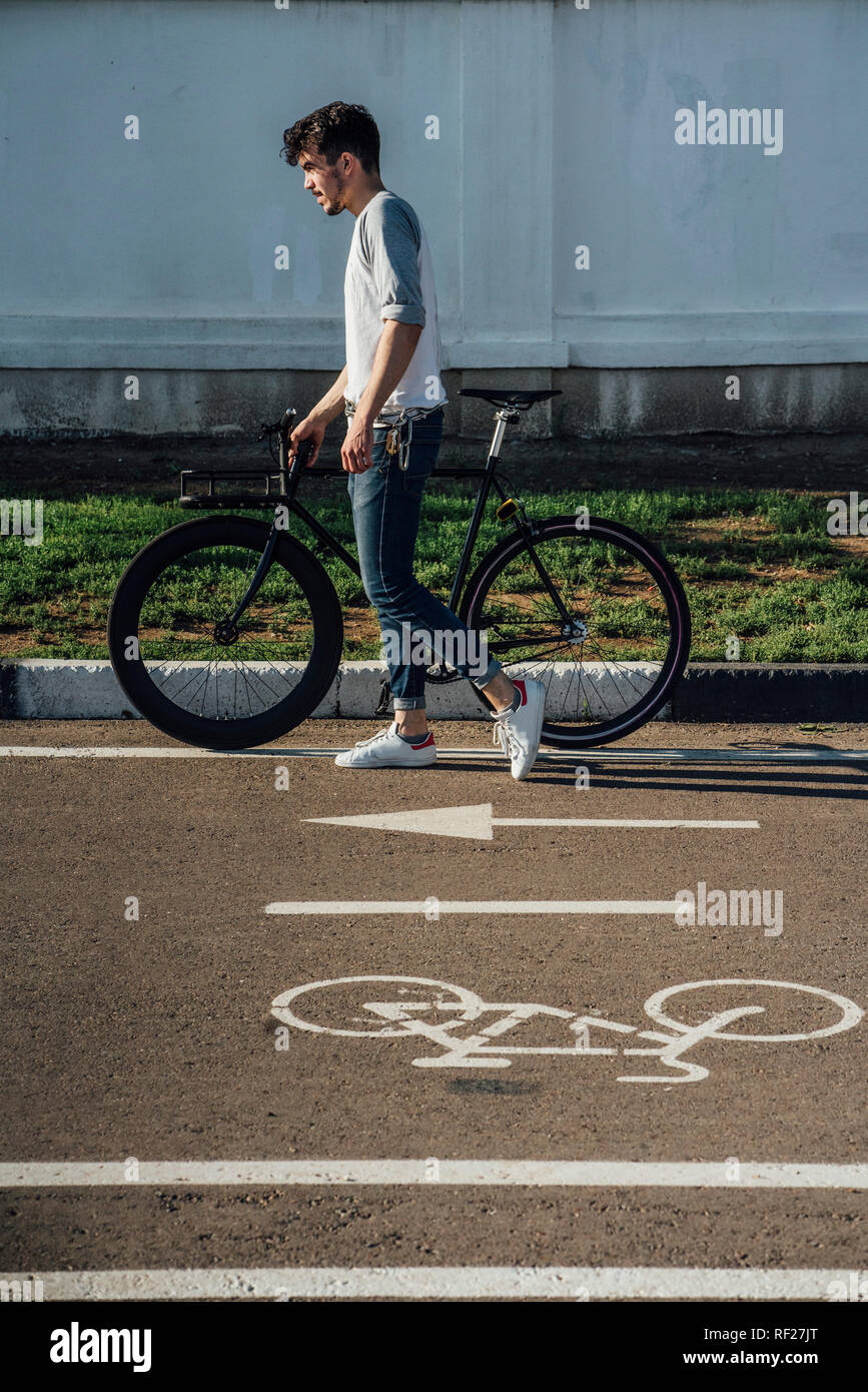 Pushing bike bicycle hi-res stock photography and images - Alamy