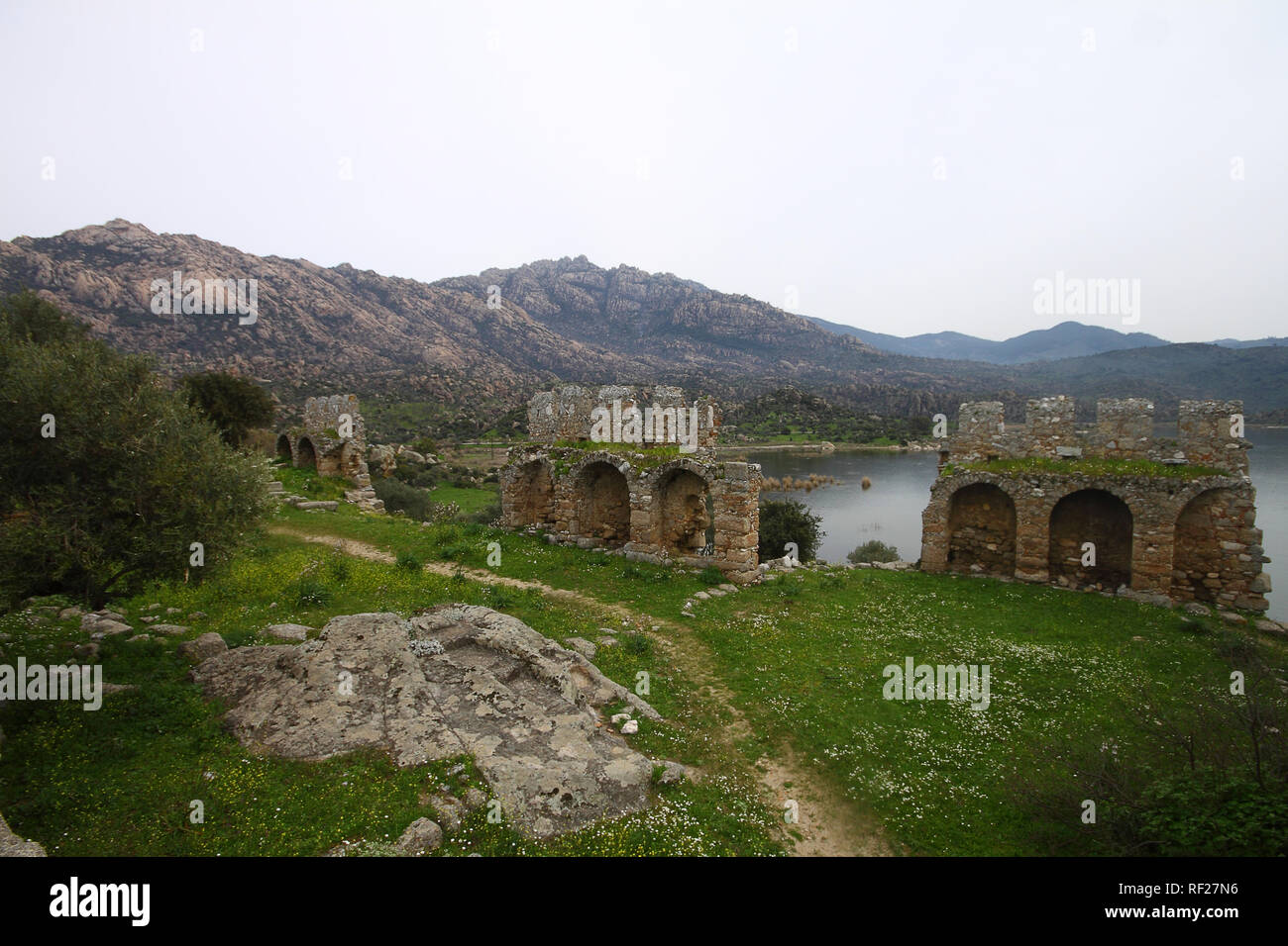 Ruined walls of castle over the lake Bafa in a nature reserve situated ...