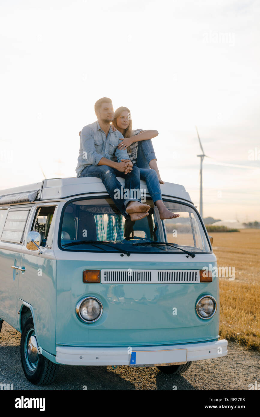 Affectionate young couple roof camper van rural landscape hi-res stock ...