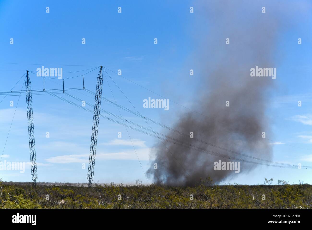 Power line with dust devil, sandstorm with lots of ash over burnt ...