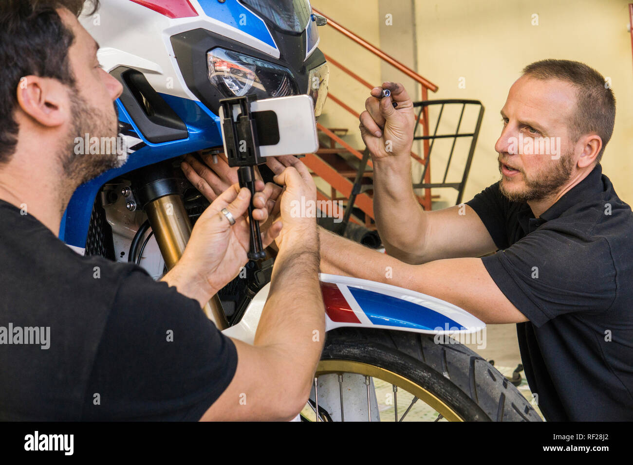 Two mechanics collaborate repair motor hi-res stock photography and ...