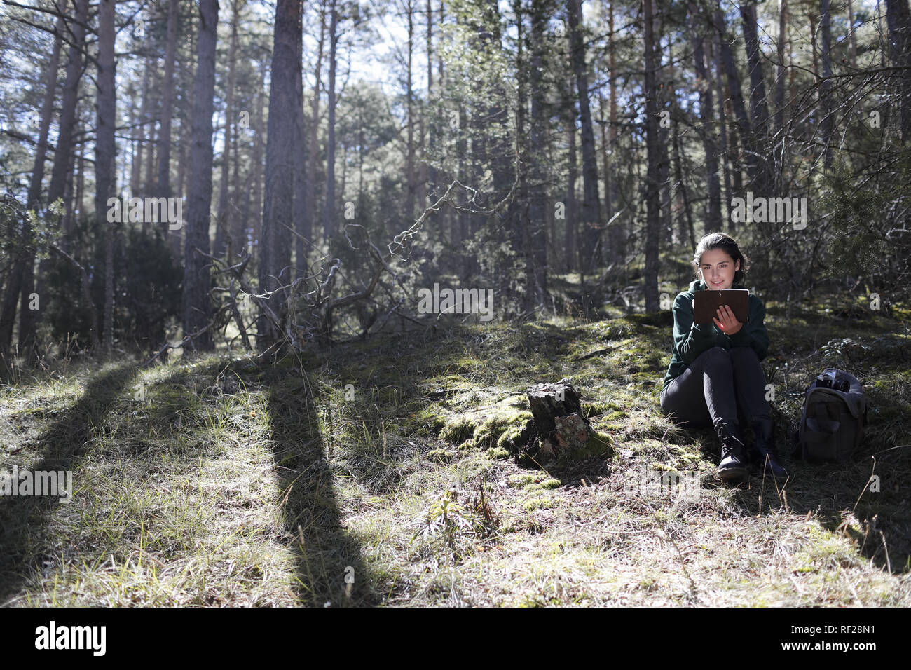 Young woman sitting forest hi-res stock photography and images - Alamy