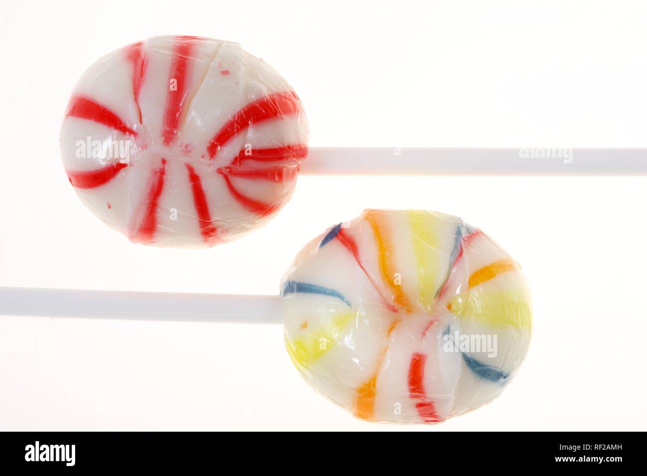 Striped red-and-white and muliticoloured lollipop suckers Stock Photo ...