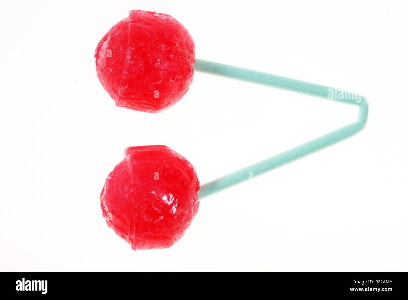 Two hard red sugar candy cherry lollipops on one folded stick, a sucker ...