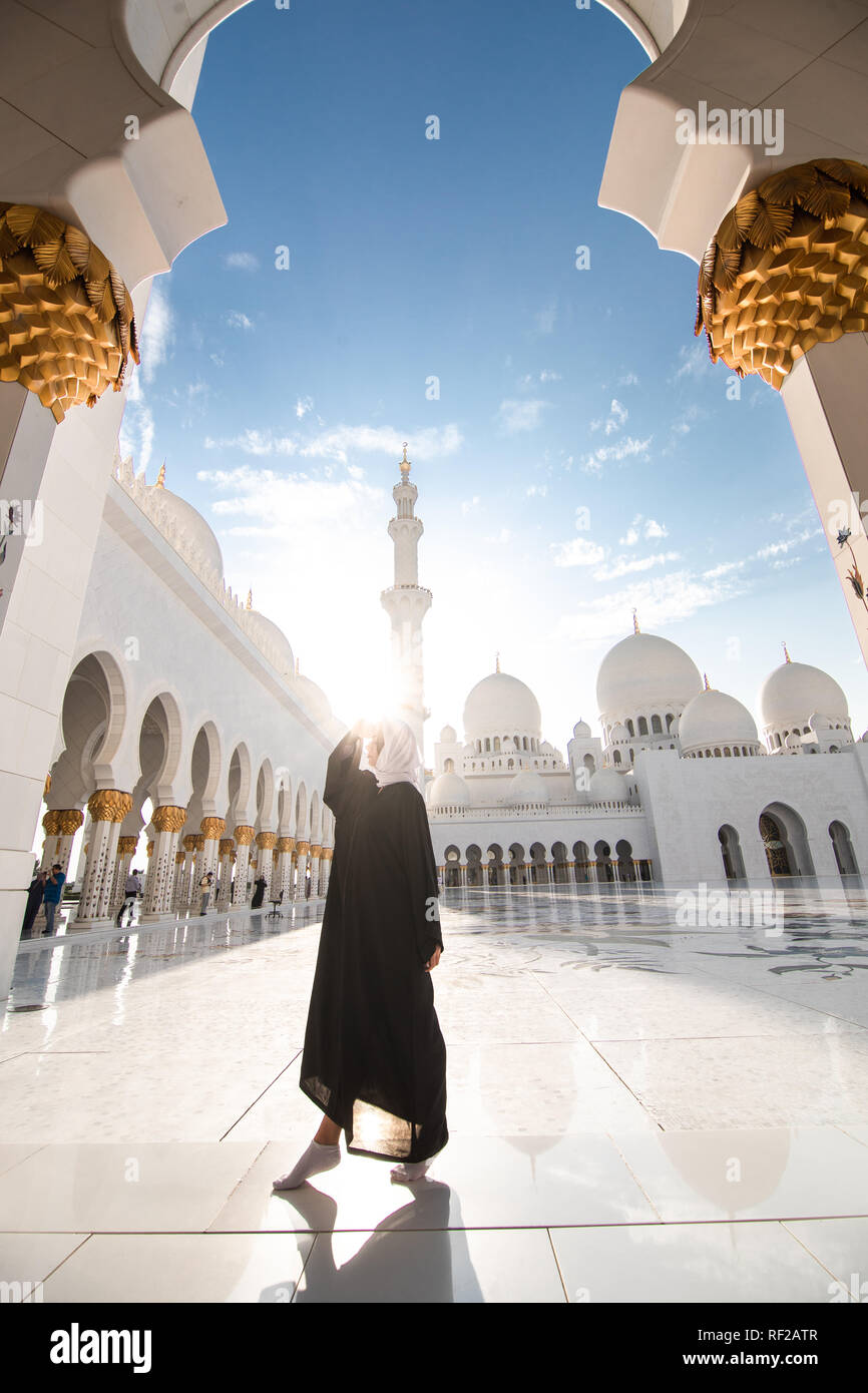 Traditionally dressed arabic woman wearing black burka wisiting Sheikh ...