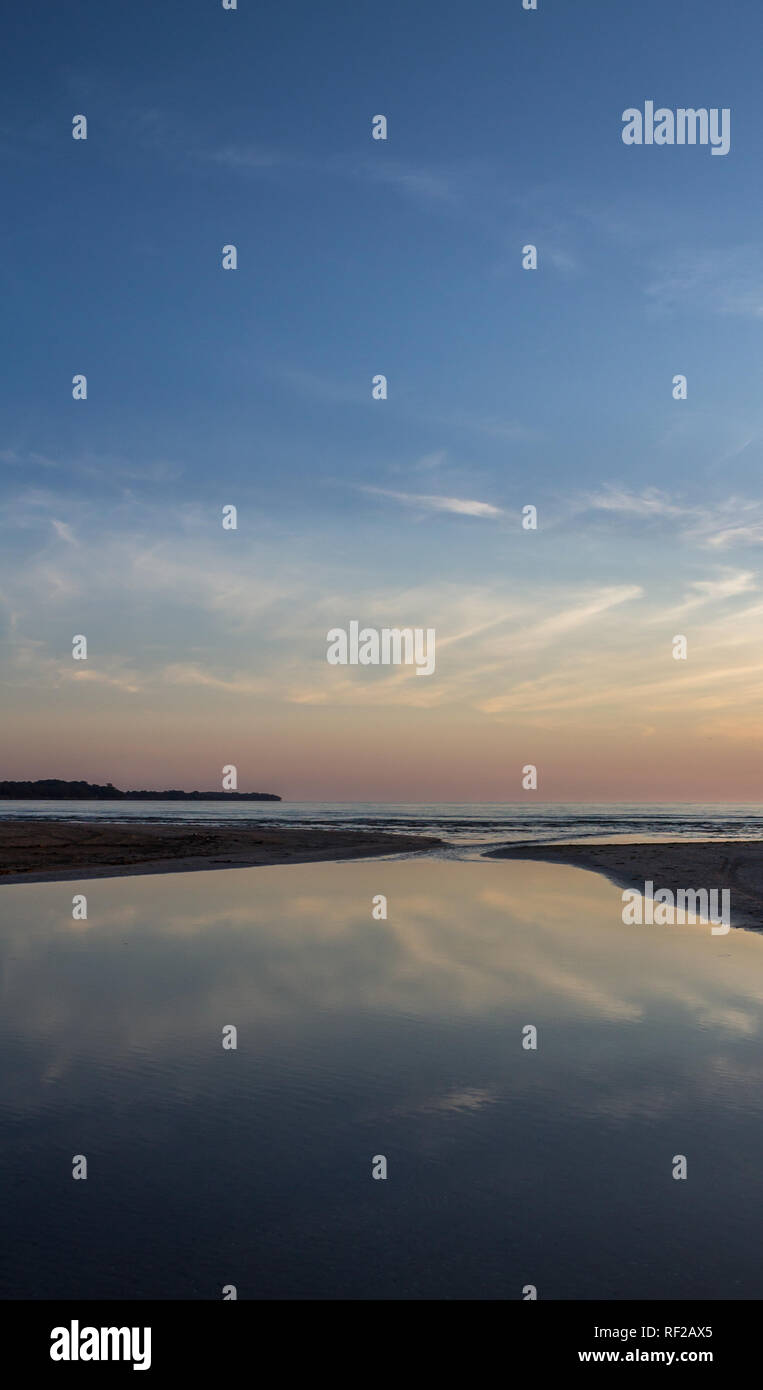 glassy river emptying into roughly lake Stock Photo - Alamy