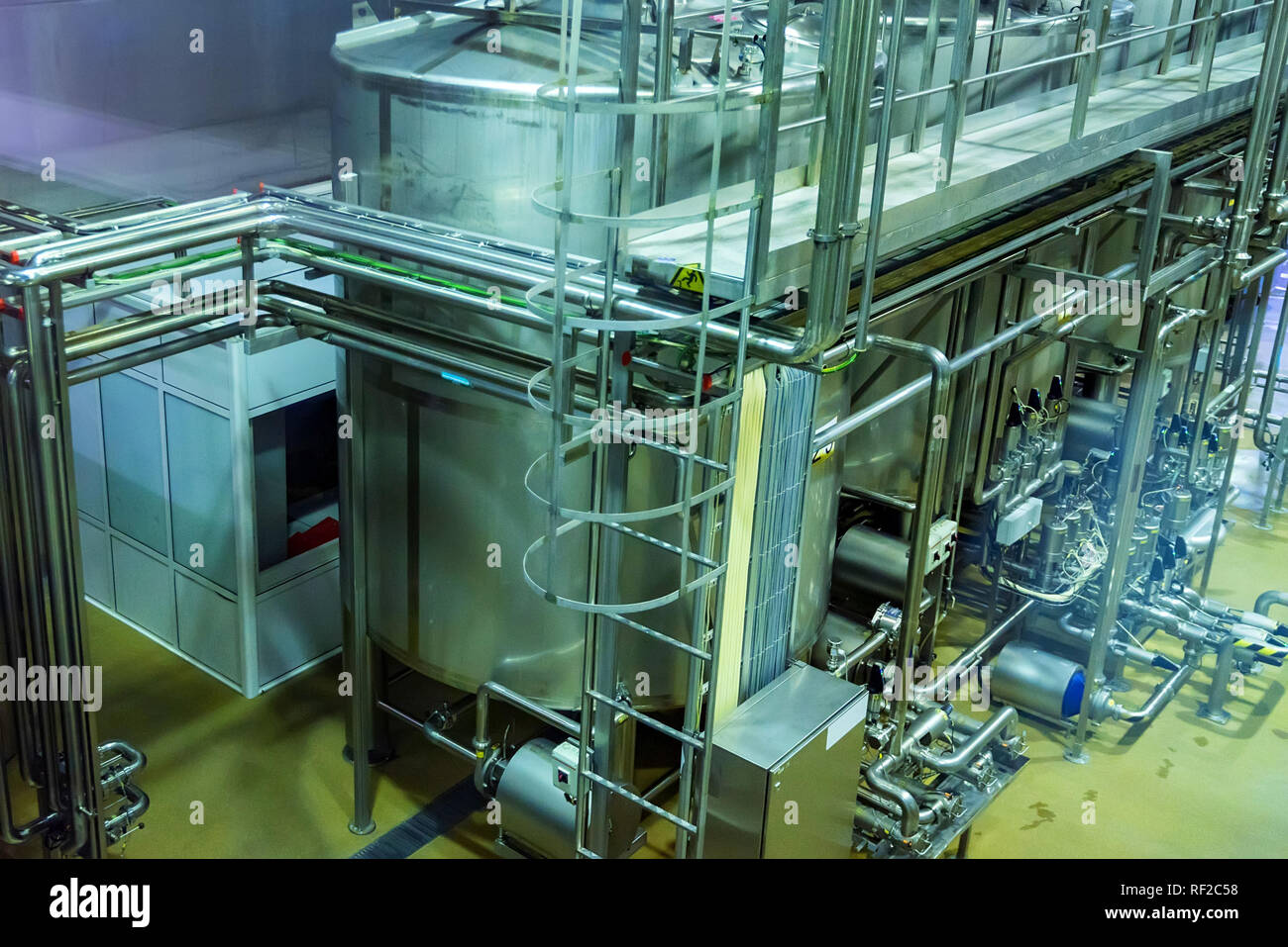 Metal reservoirs at a soft drink factory Stock Photo - Alamy