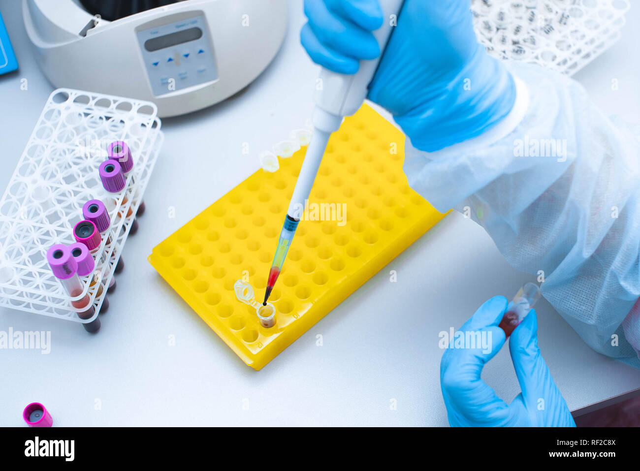 Dna test in the lab. Dispenser with blood and test tubes close-up. A ...