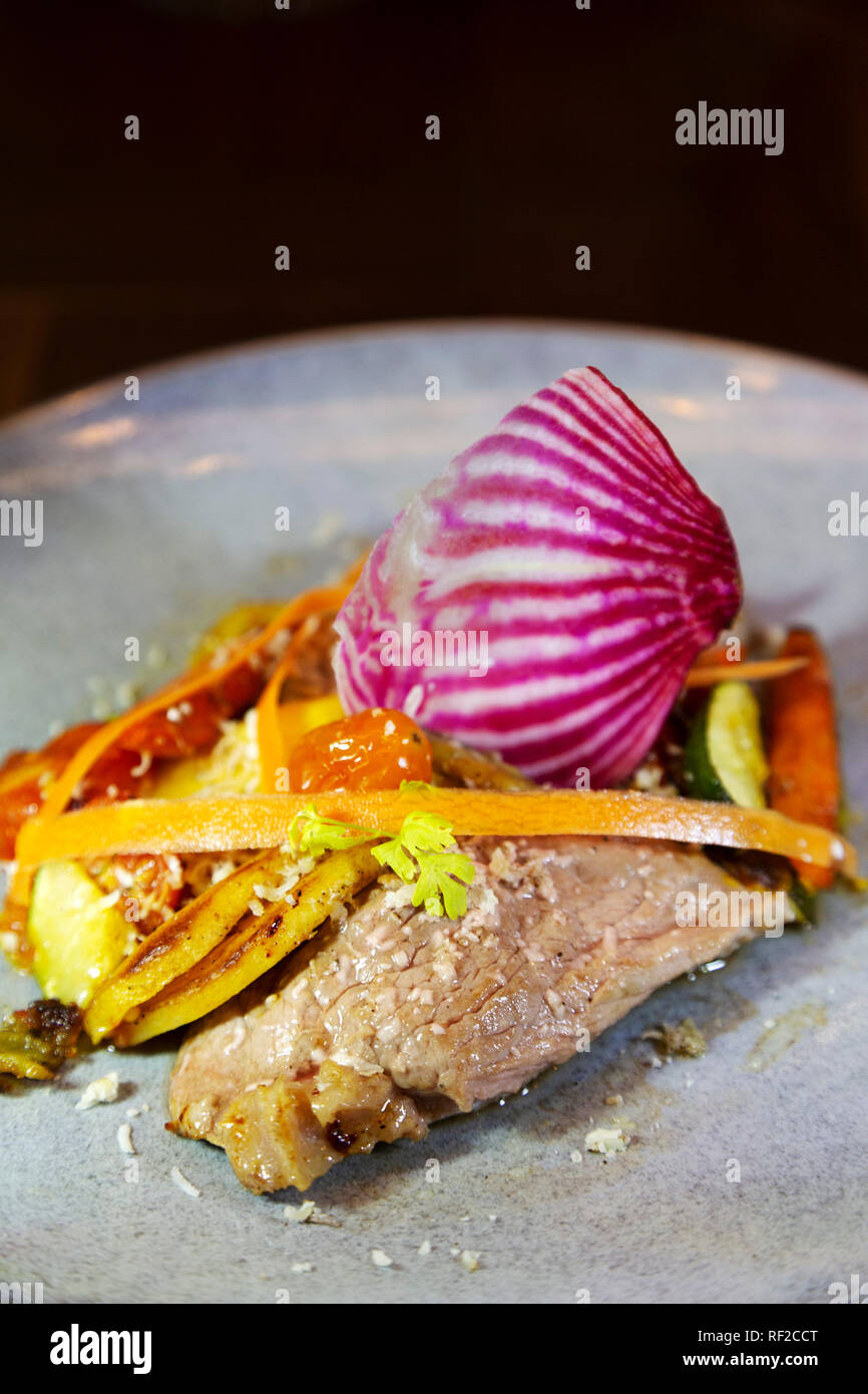 Veal served with roasted vegetables in northern France Stock Photo - Alamy