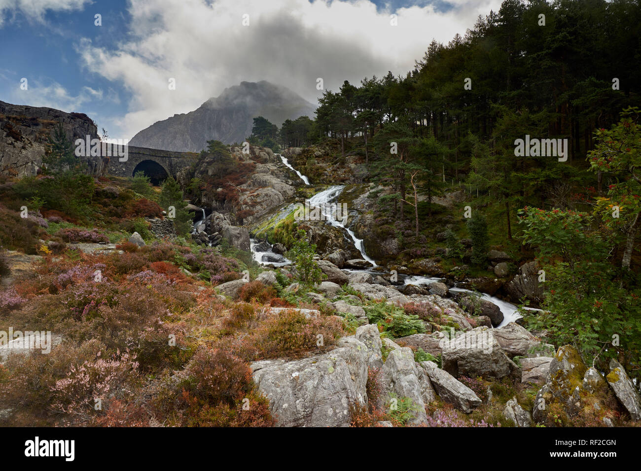 Llyn Ogwen waterfall with Tryfan in the distance, Snowdonia, Wales ...