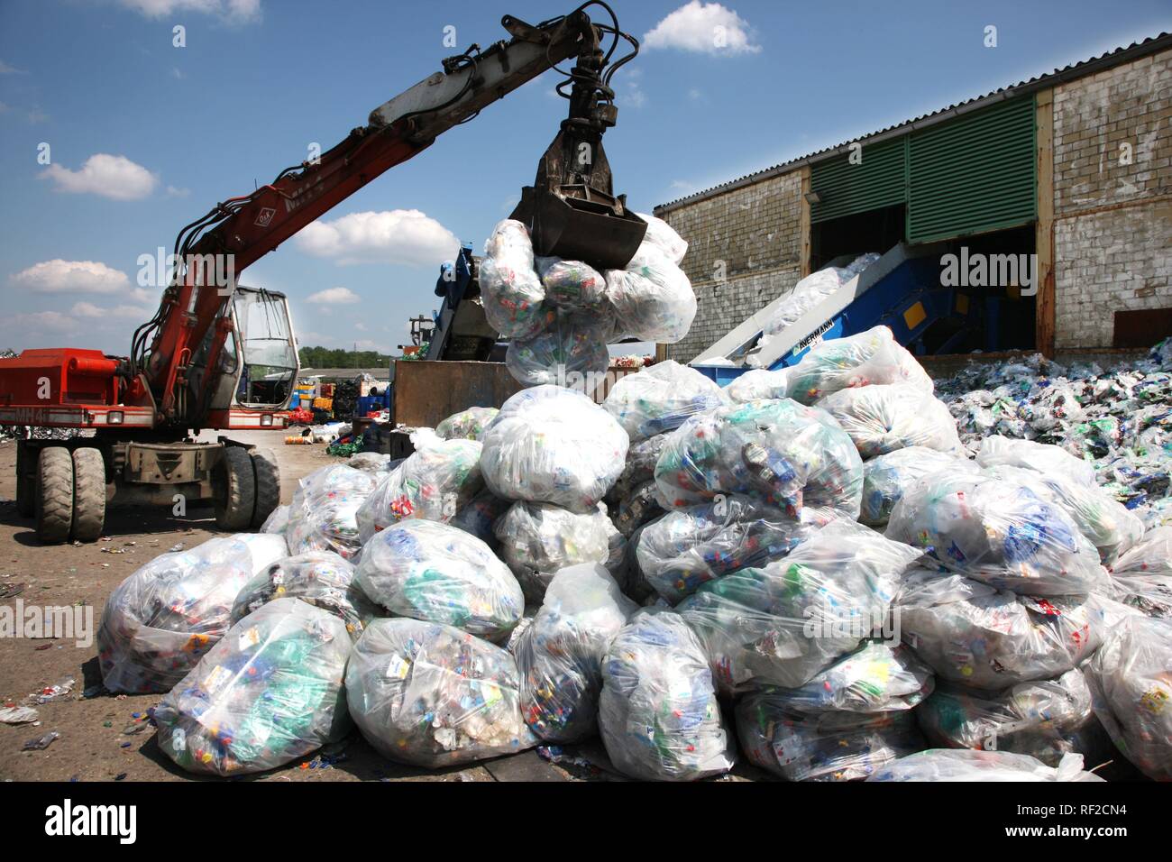 Plastic recycling, PET bottles and plastic rubbish are shredded and ...