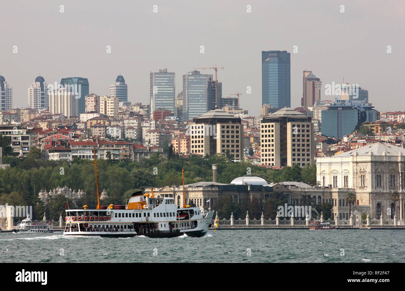 Dolmabahce Palace on the Bosporus River, skyline of Istanbul at back ...