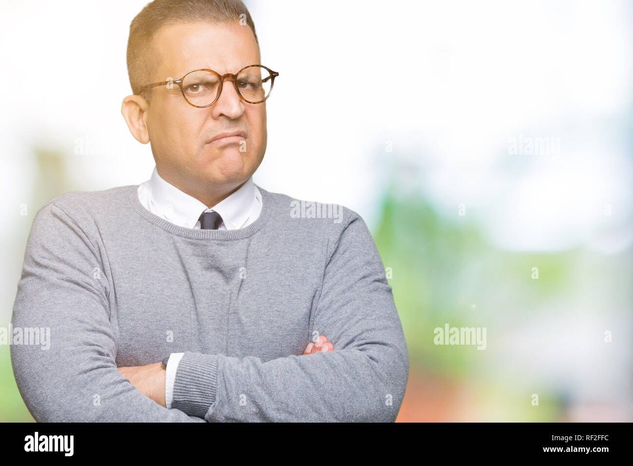 Middle age bussines arab man wearing glasses over isolated background ...