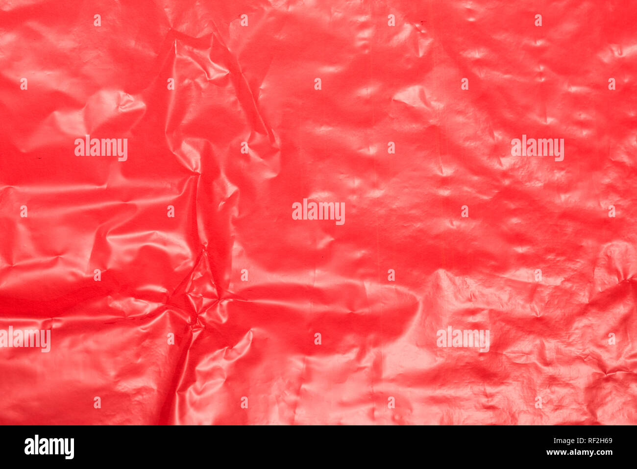 Wrinkled red plastic sheet for background or text Stock Photo - Alamy