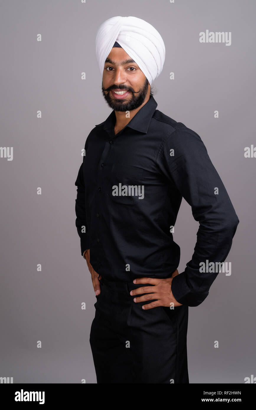 Young Indian Sikh businessman wearing white turban Stock Photo - Alamy