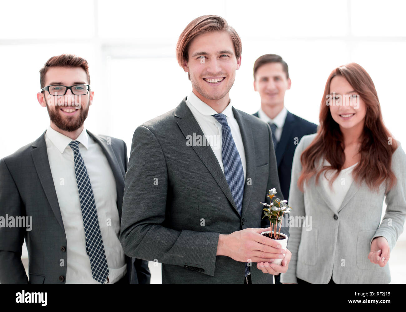 close up.a group of young people with a plant sprout Stock Photo - Alamy