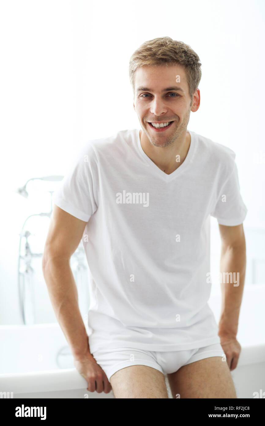 Handsome guy in the bathroom Stock Photo - Alamy