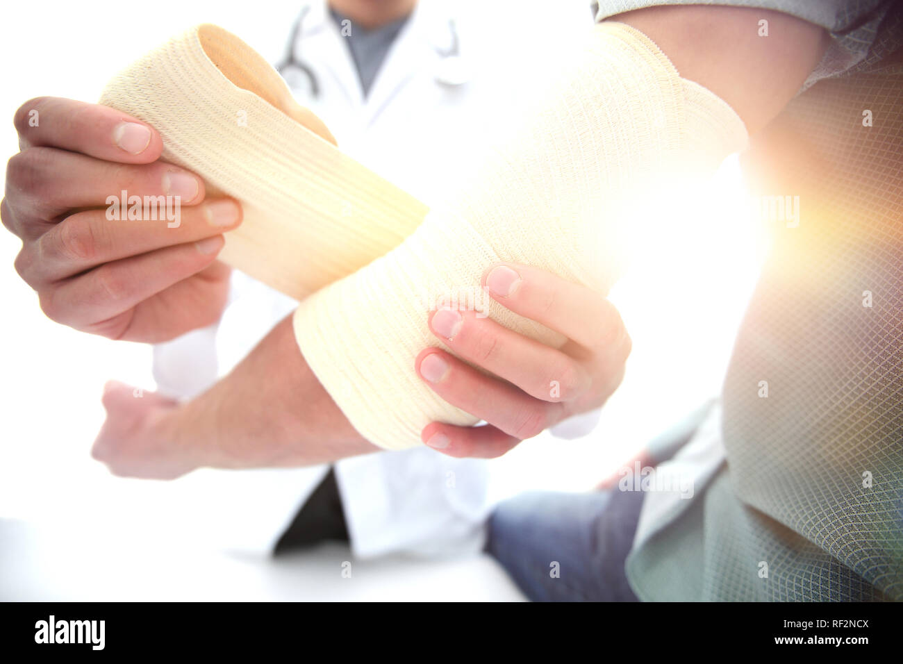 Doctor applying bandage to patients hand and wrist hi-res stock ...