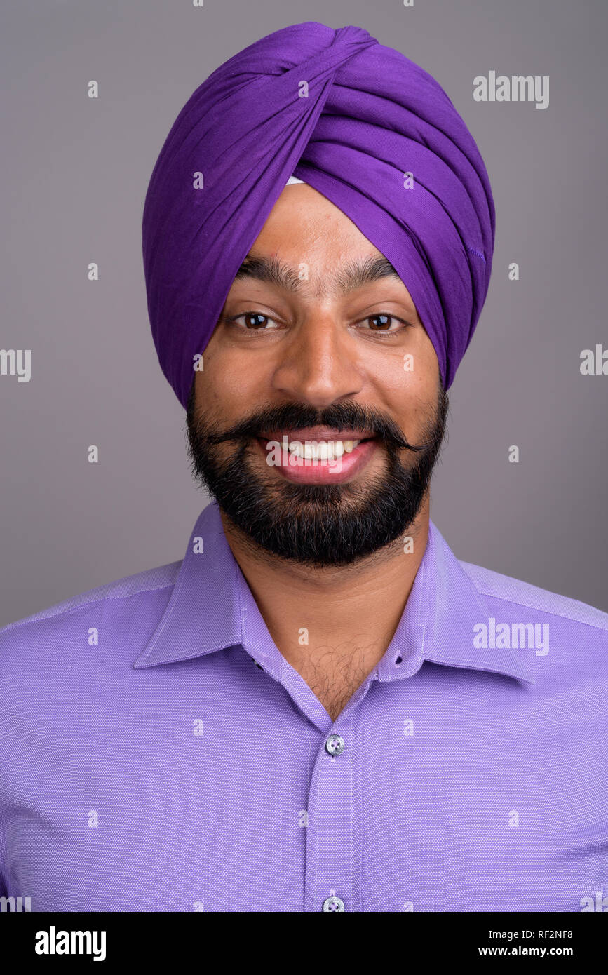 Face of Indian Sikh businessman wearing turban and smiling Stock Photo ...