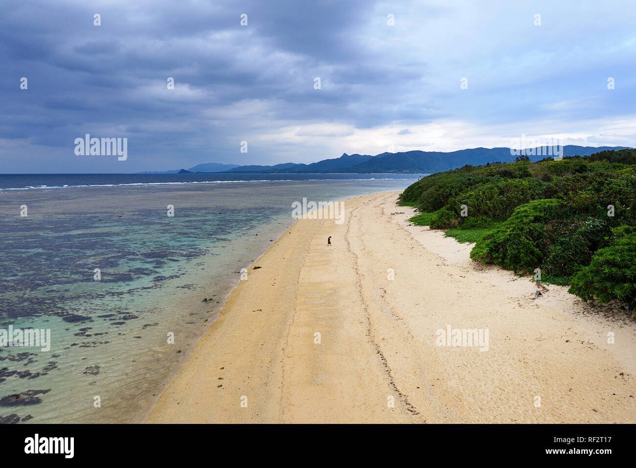 Aerial view of moody weather over a beautiful tropical beach, taken by ...