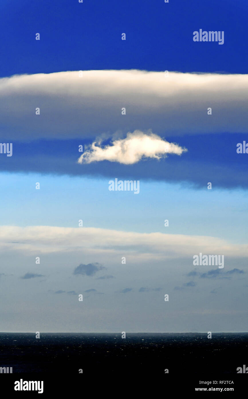 Varied blue sky and clouds with small white cloud centre Stock Photo ...