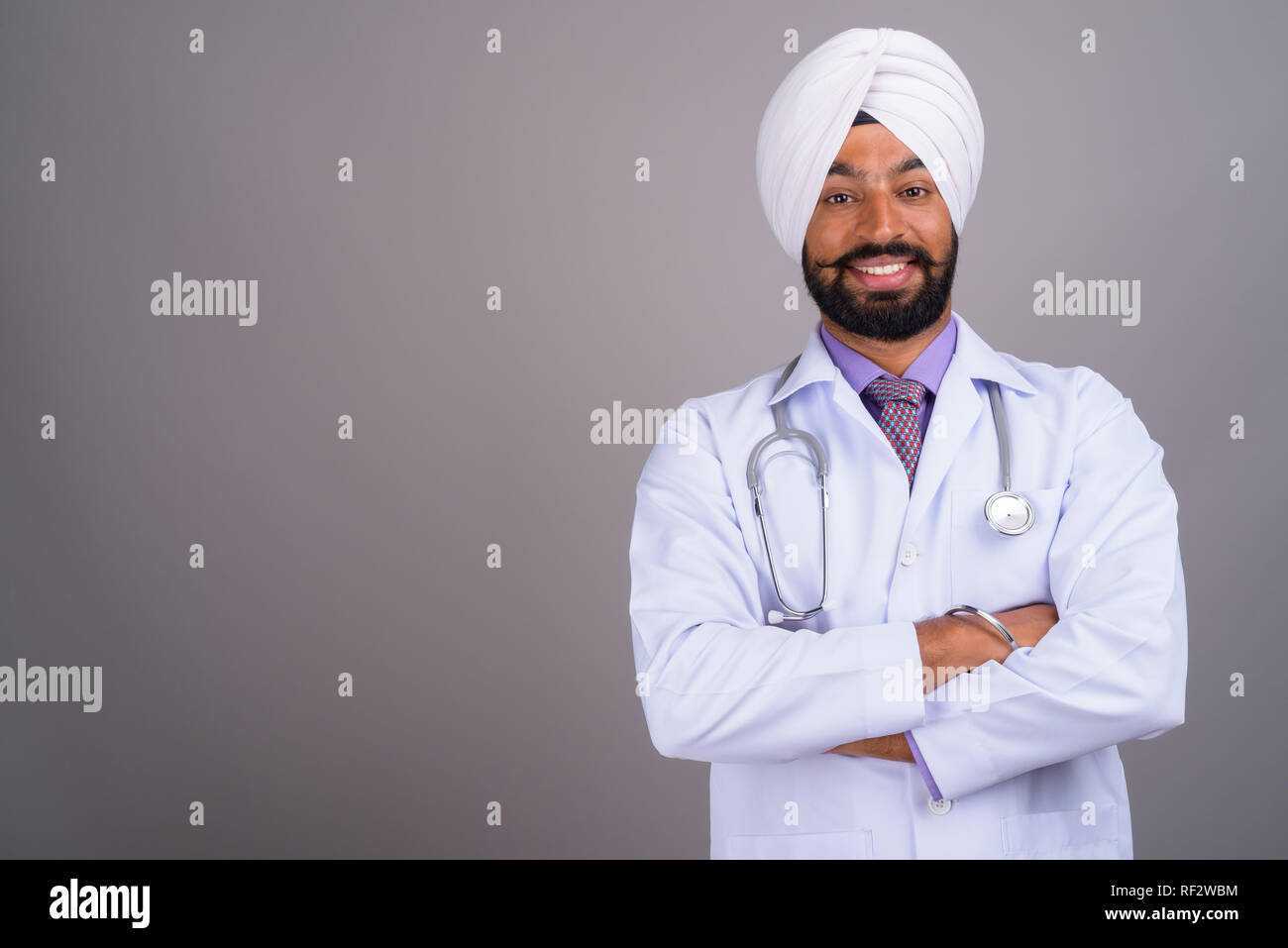 Portrait of young Indian Sikh man doctor smiling Stock Photo - Alamy