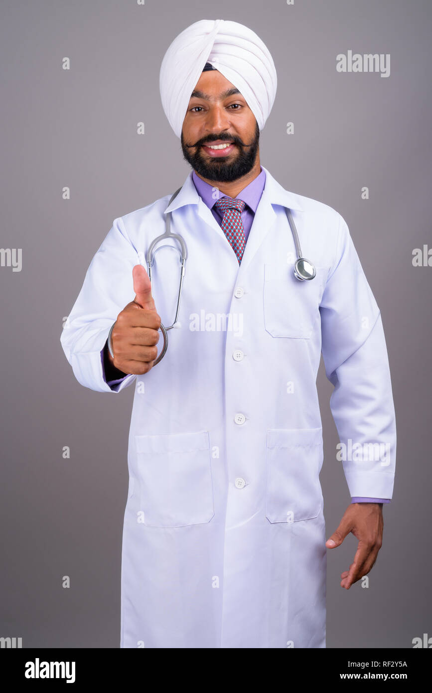 Young Indian Sikh man doctor smiling and giving thumb up Stock Photo ...
