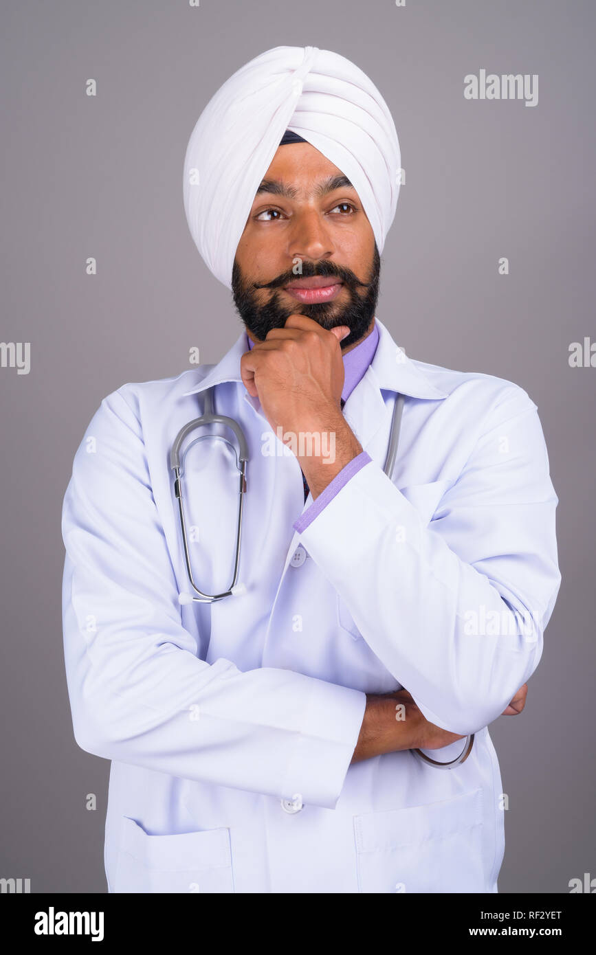 Portrait of young Indian Sikh man doctor thinking Stock Photo - Alamy