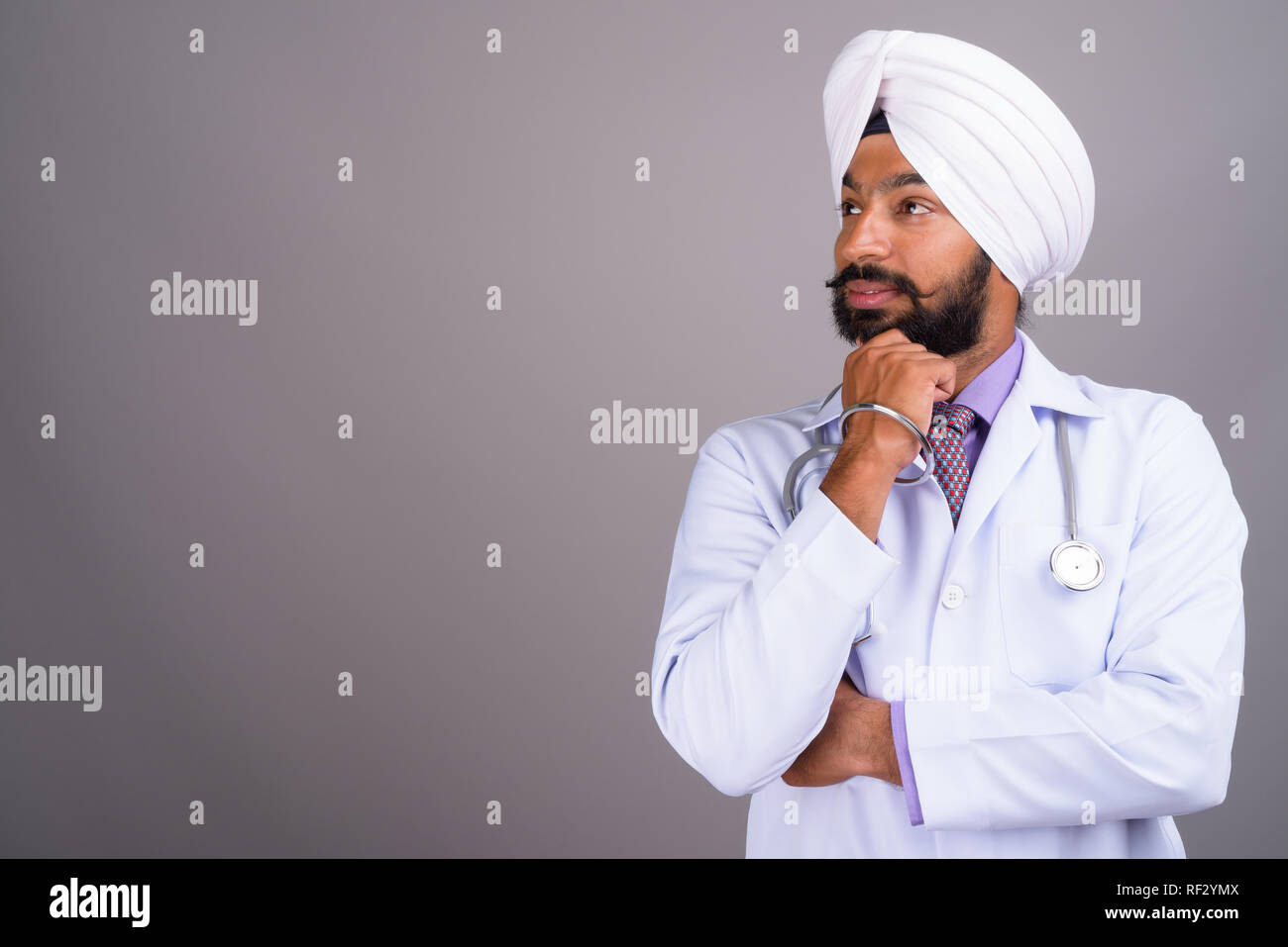 Portrait of young Indian Sikh man doctor thinking Stock Photo - Alamy