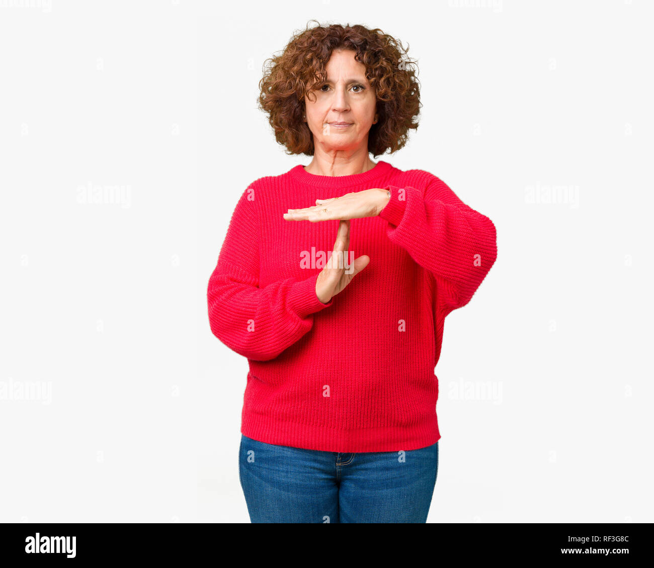 Beautiful middle ager senior woman red winter sweater over isolated ...