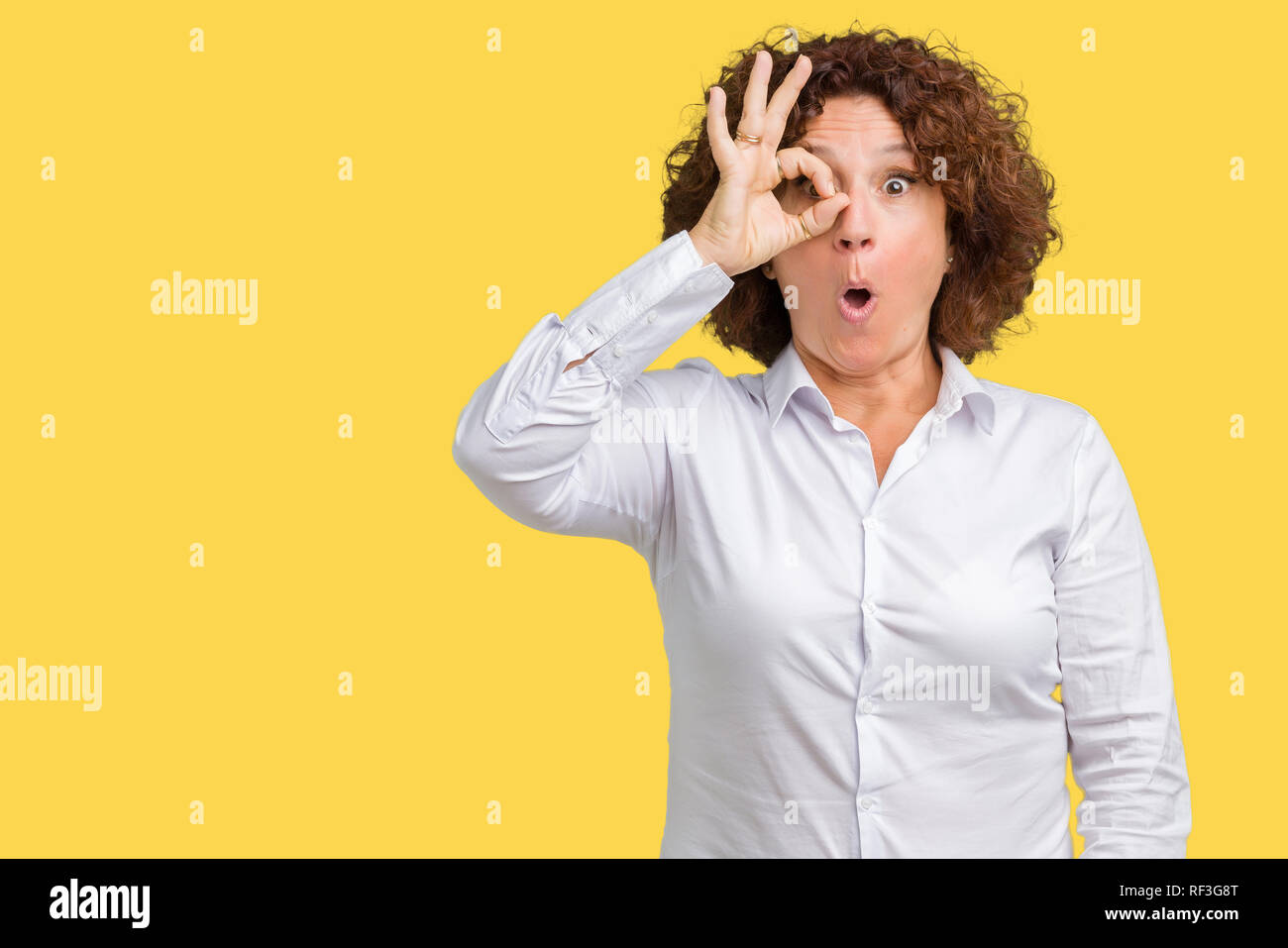 Beautiful middle ager senior businees woman over isolated background ...