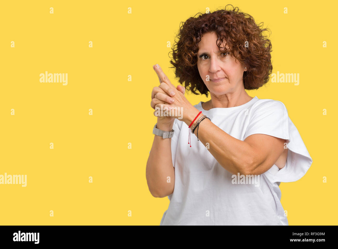 Beautiful middle ager senior woman wearing white t-shirt over isolated ...
