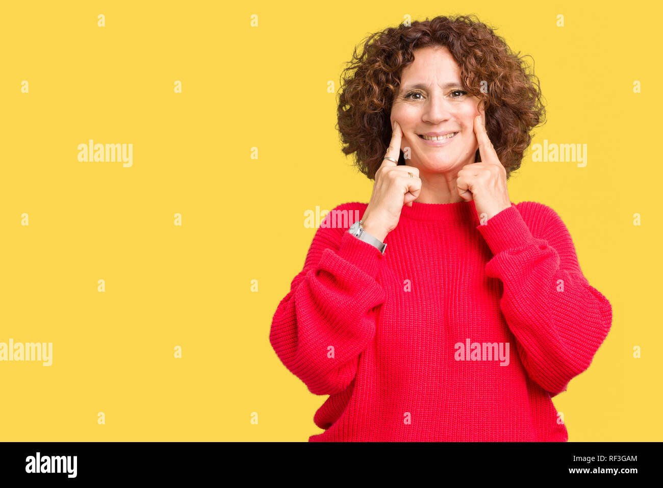 Beautiful middle ager senior woman red winter sweater over isolated ...