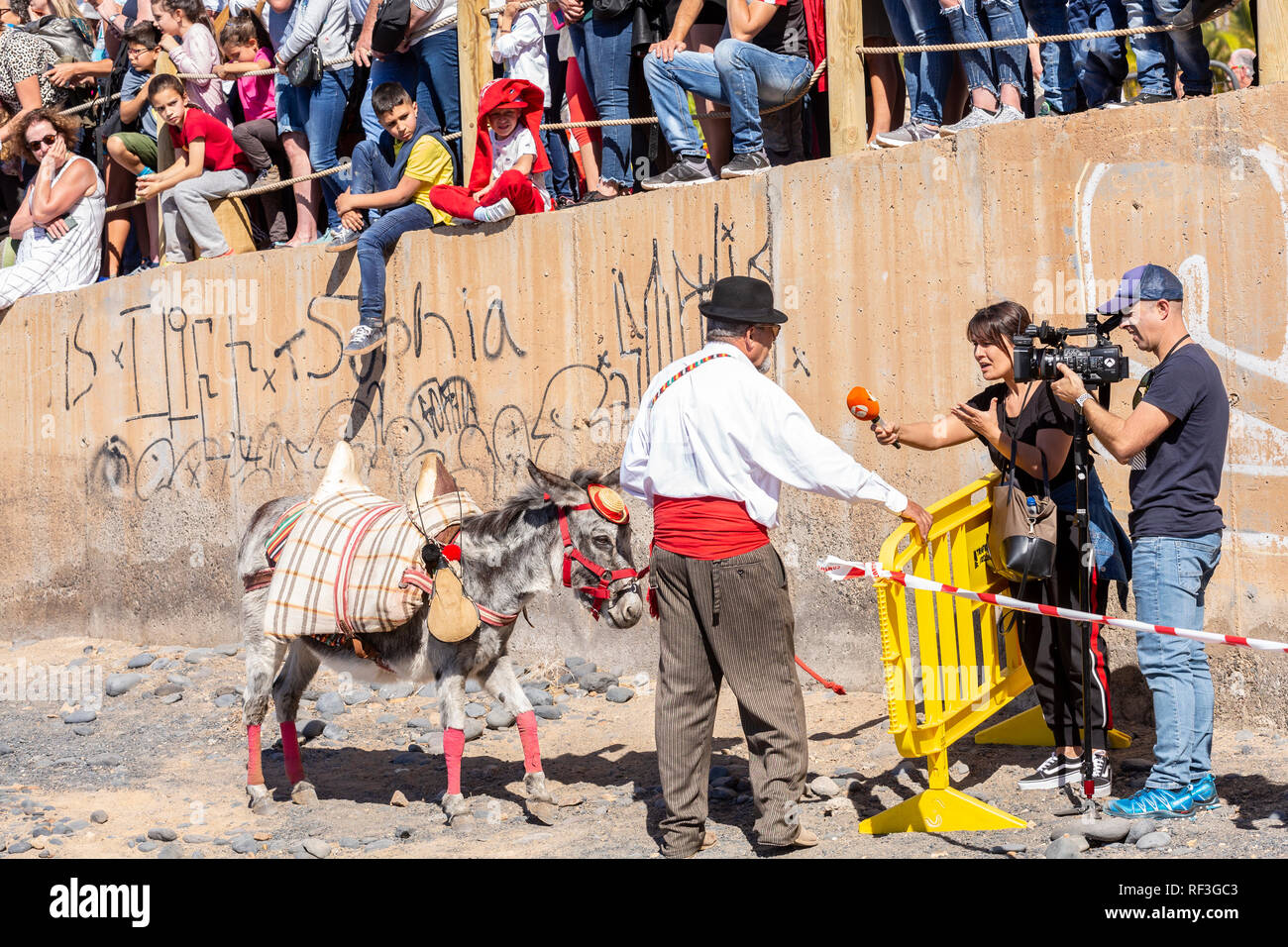 TV crew interviewing a man in traditional Canarian costume with a ...