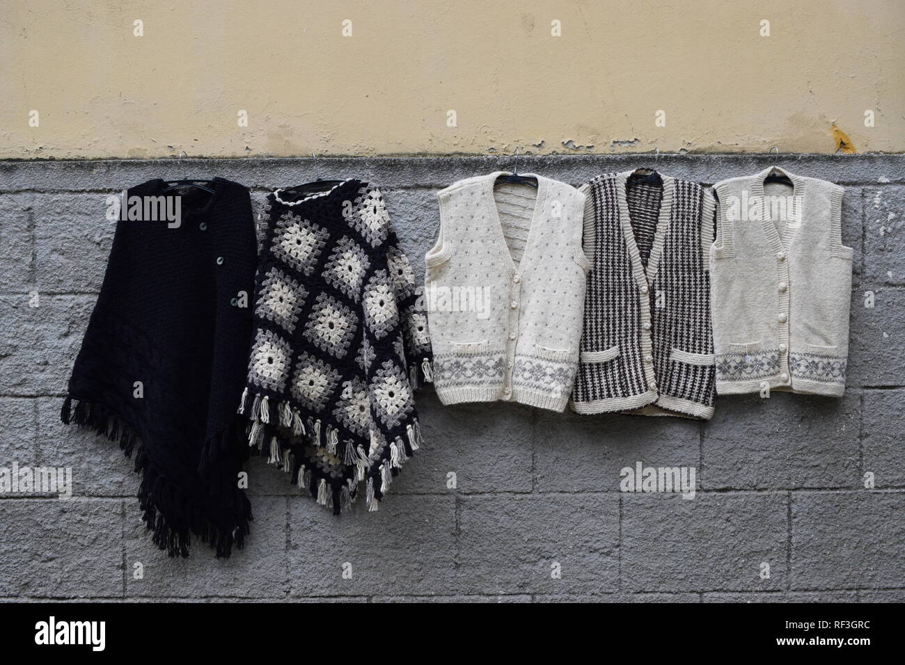 Sweaters on the wall Stock Photo - Alamy