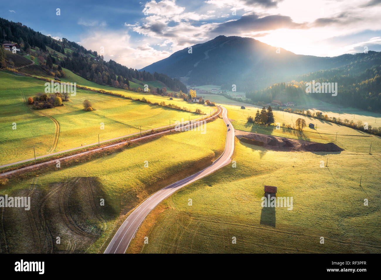 Aerial view of the road in mountain valley at sunrise in Dolomites ...