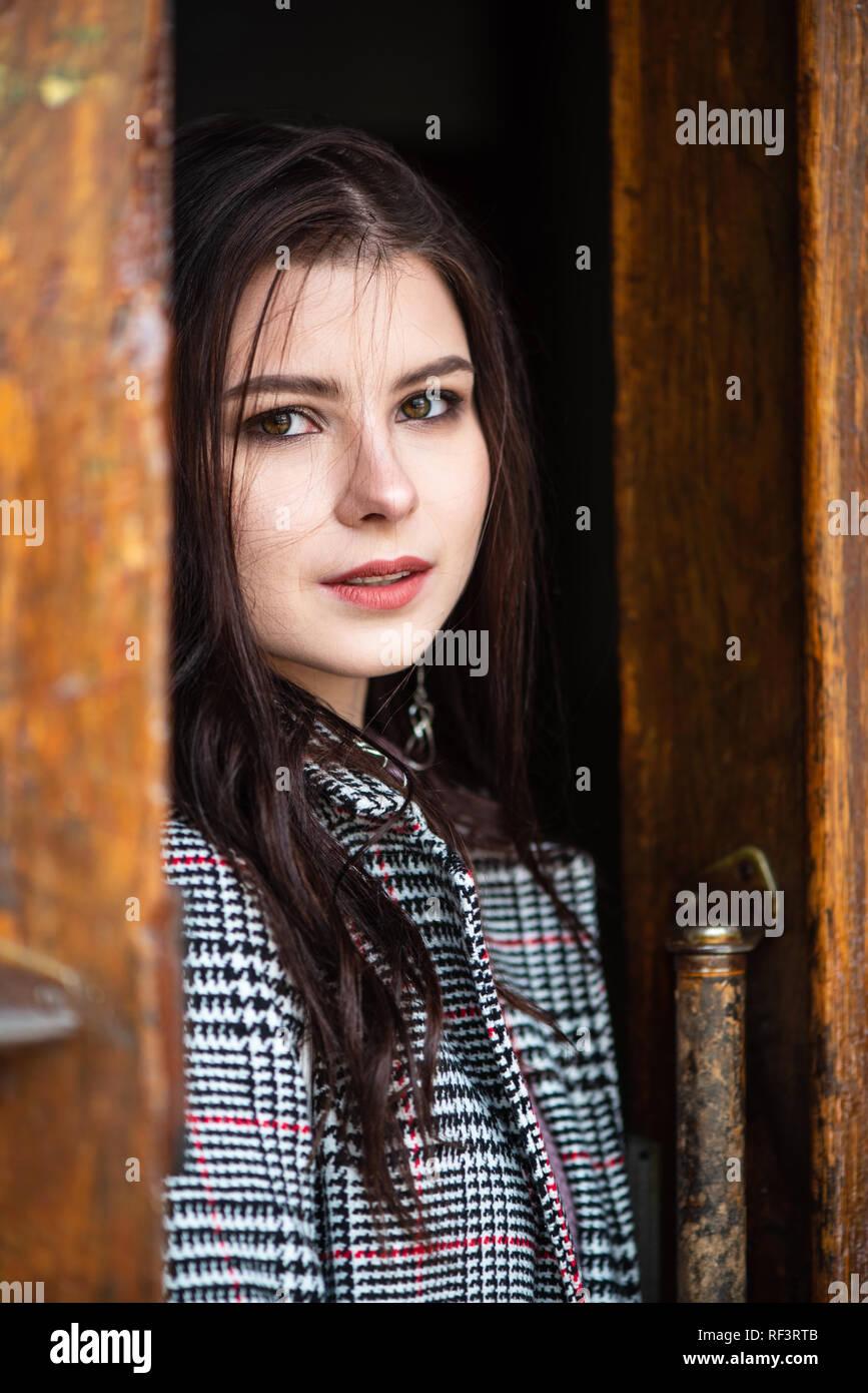 Portrait of a beautiful young woman with a clear look. Near the old oak ...