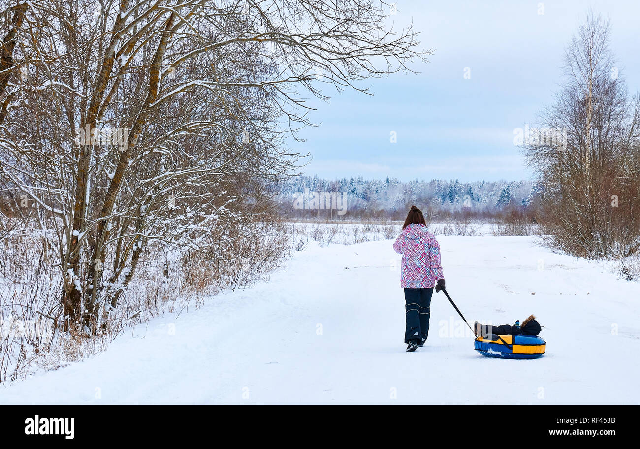 Boy pushing sled hi-res stock photography and images - Alamy