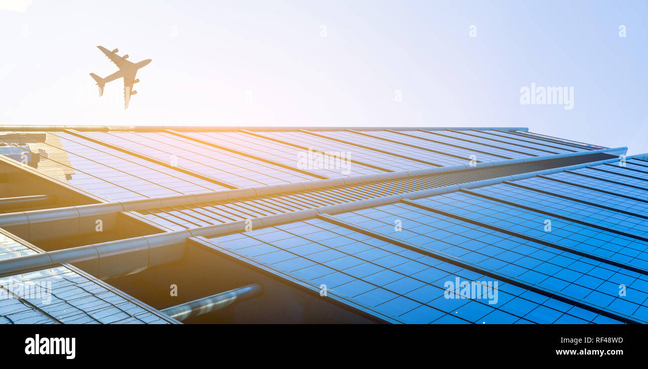 Bottom angle view of airplane in sky over city buildings Stock Photo ...