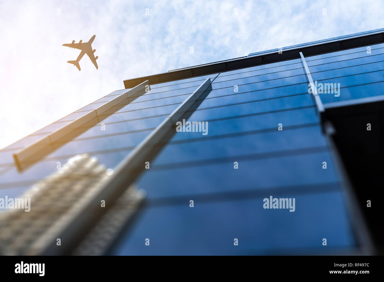 Bottom angle view of airplane in sky over city buildings Stock Photo ...