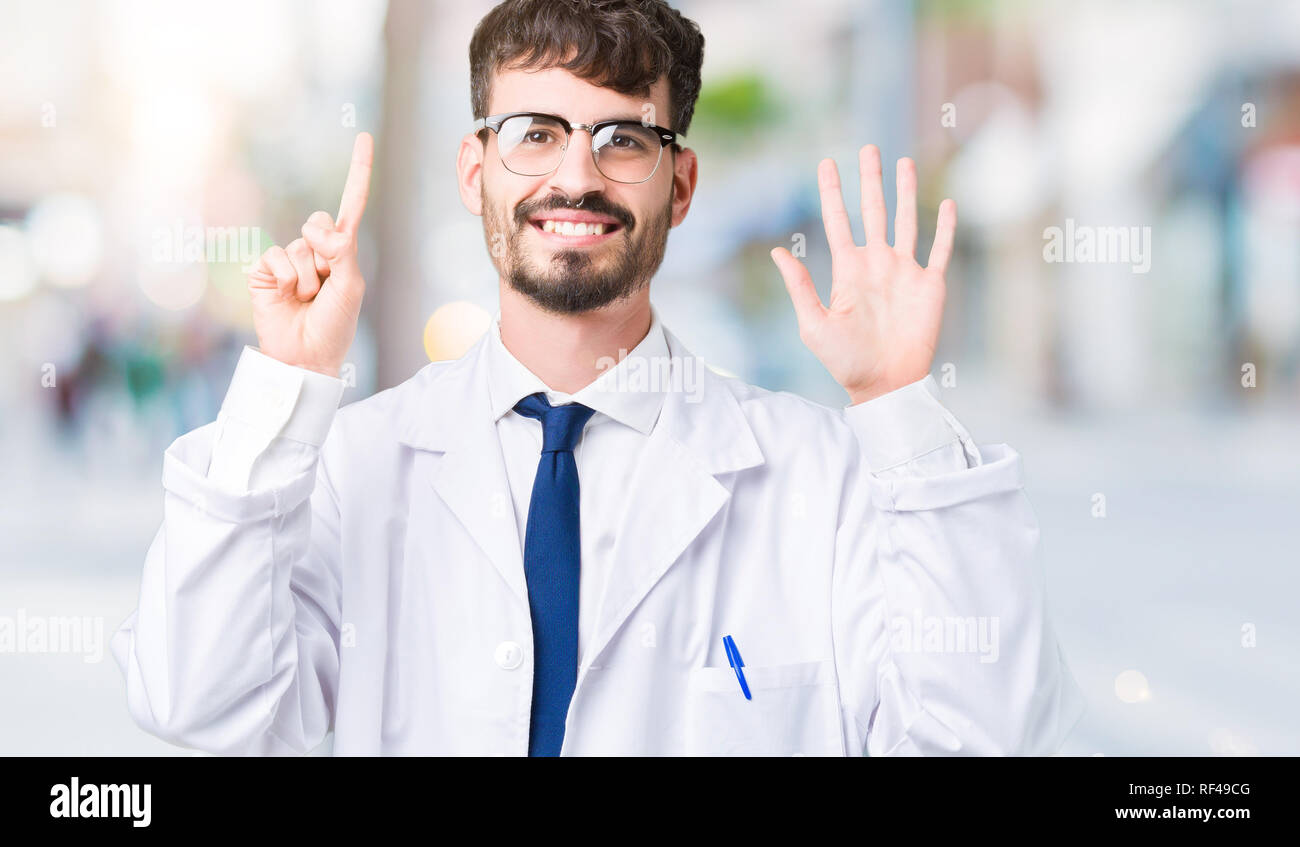Young professional scientist man wearing white coat over isolated ...