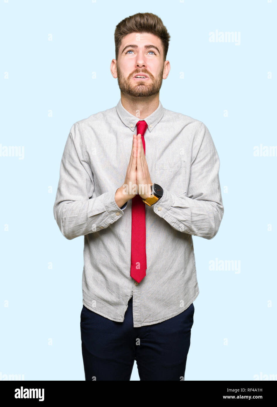 Desperate young man pleading with hands hi-res stock photography and ...
