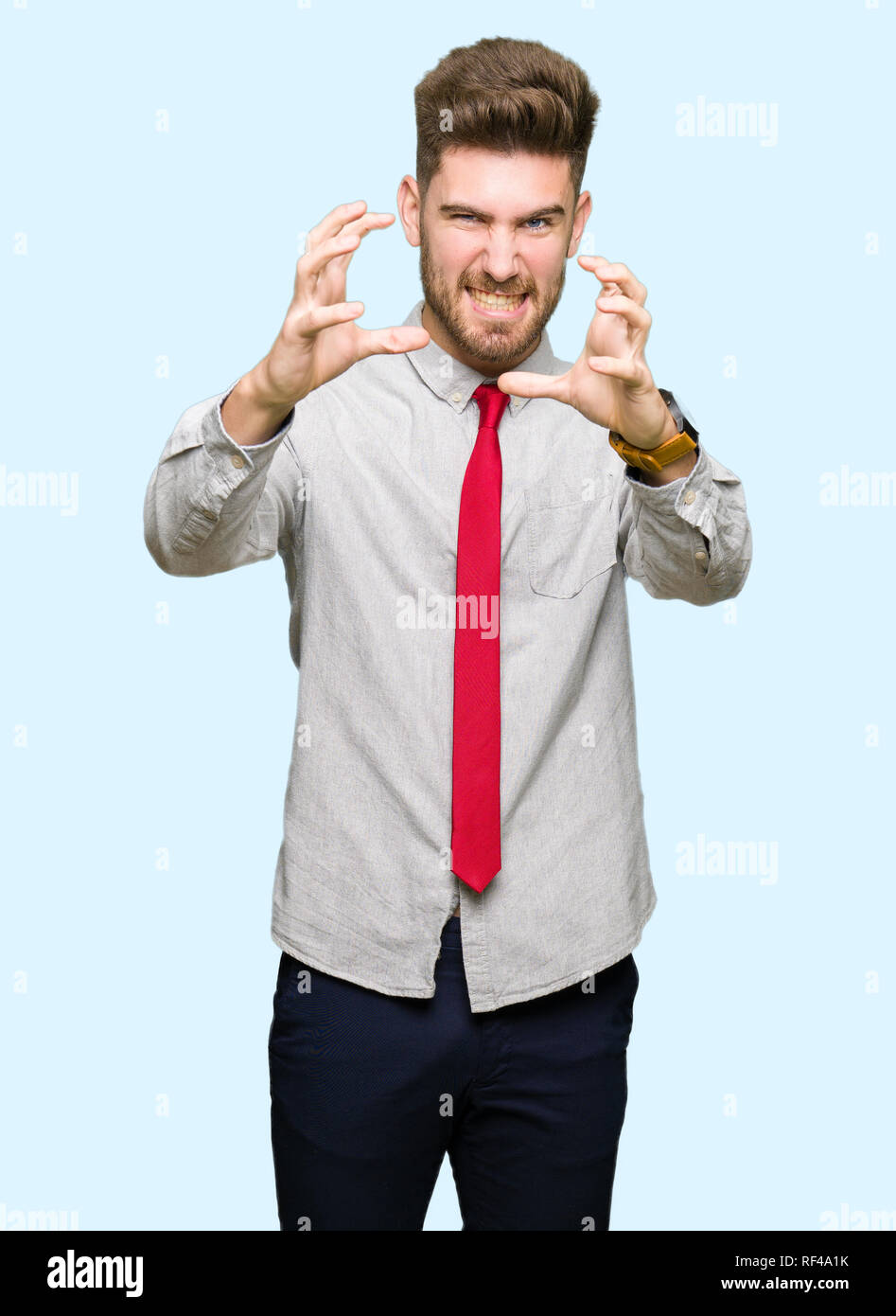 Young handsome business man Shouting frustrated with rage, hands trying ...