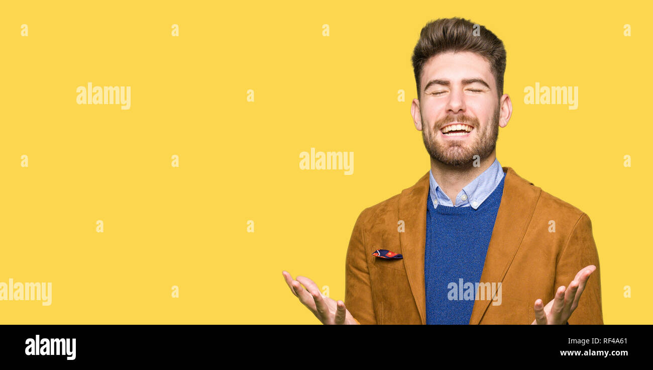Young handsome business man celebrating mad and crazy for success with ...
