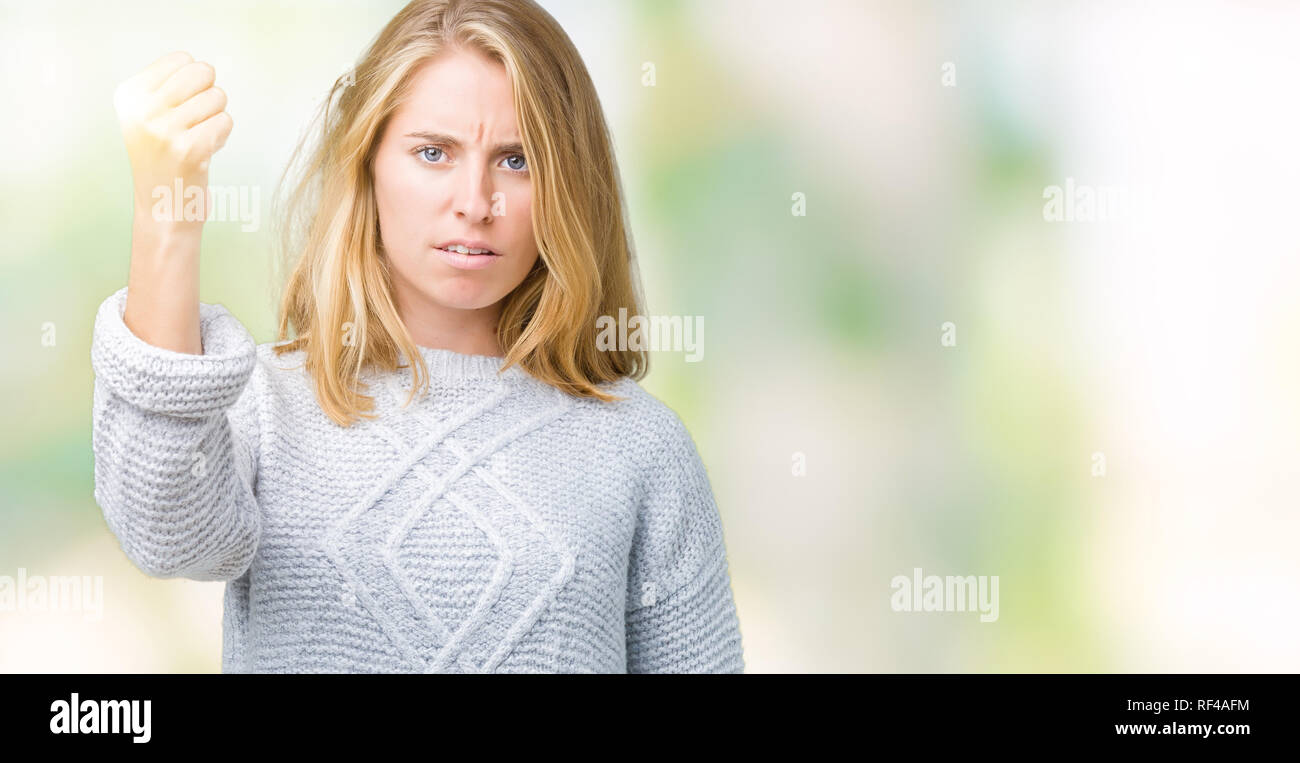 Beautiful young woman wearing winter sweater over isolated background ...