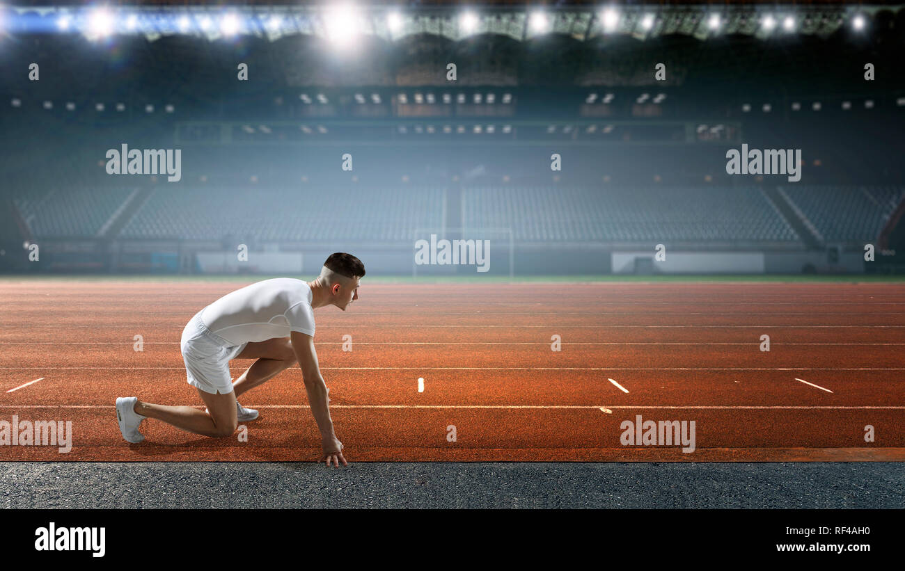 Athlete man running on racetrack at stadium. Mixed media Stock Photo ...