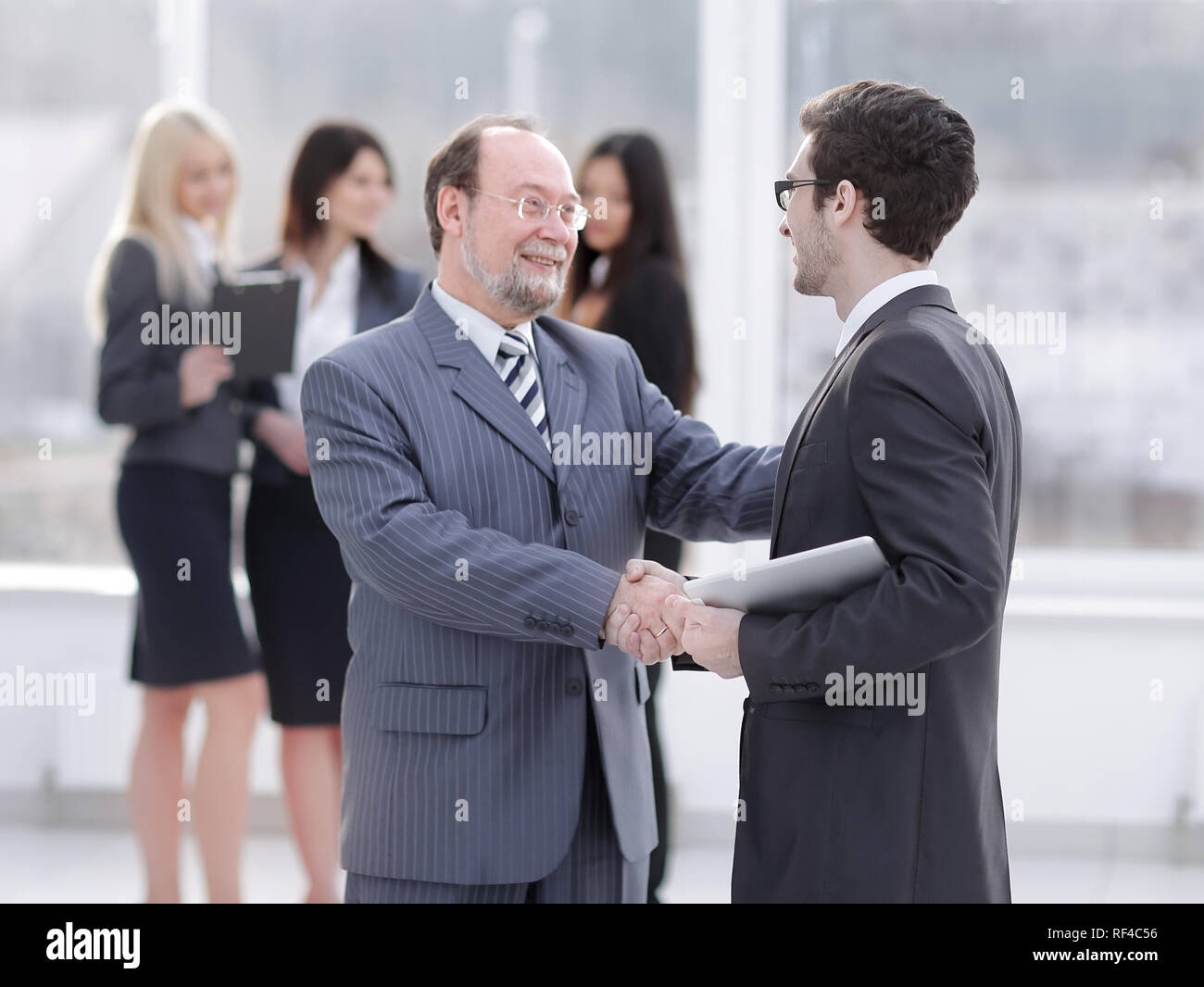 project Manager shaking hands with the employee prior to the seminar ...